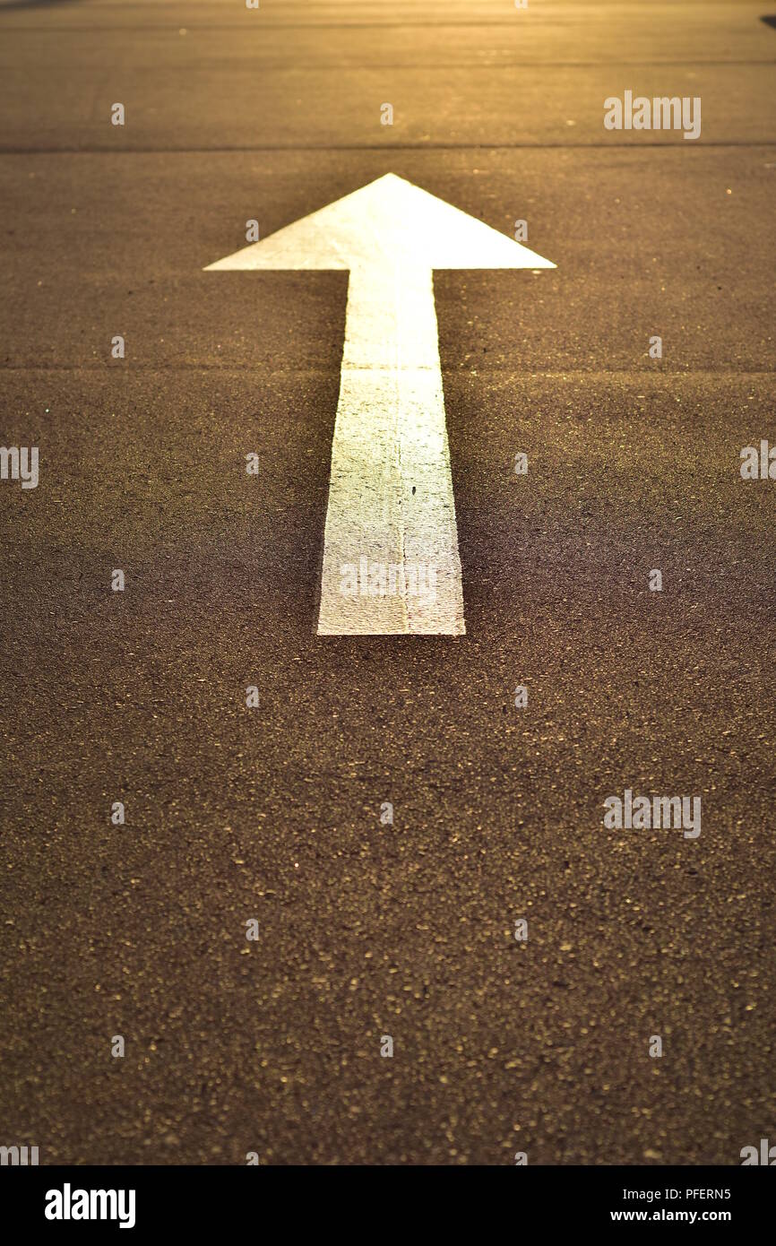 White road marking arrow pointing hi-res stock photography and images ...