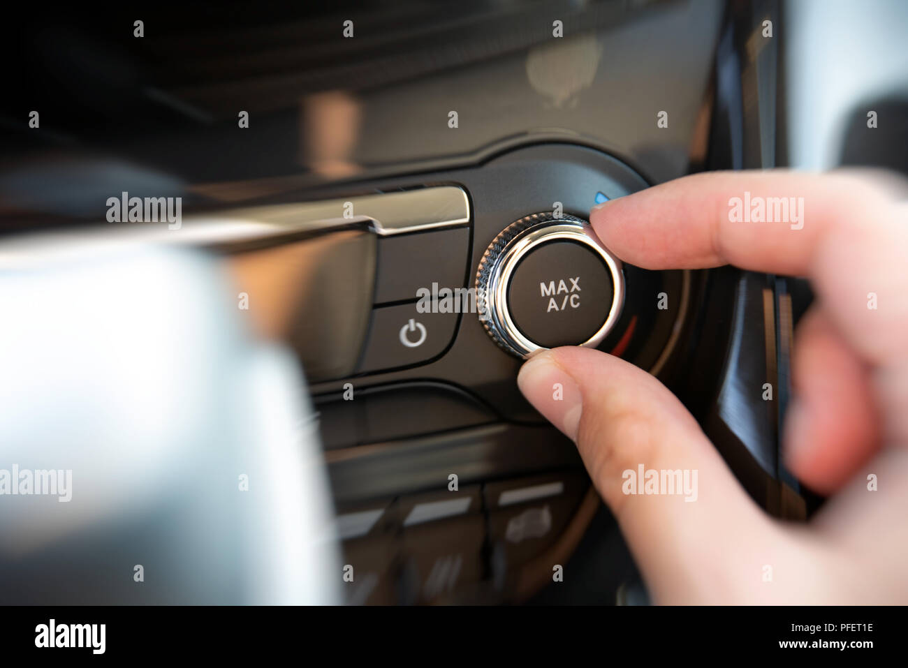 Man turning on car air conditioning system. Air conditioning button ...