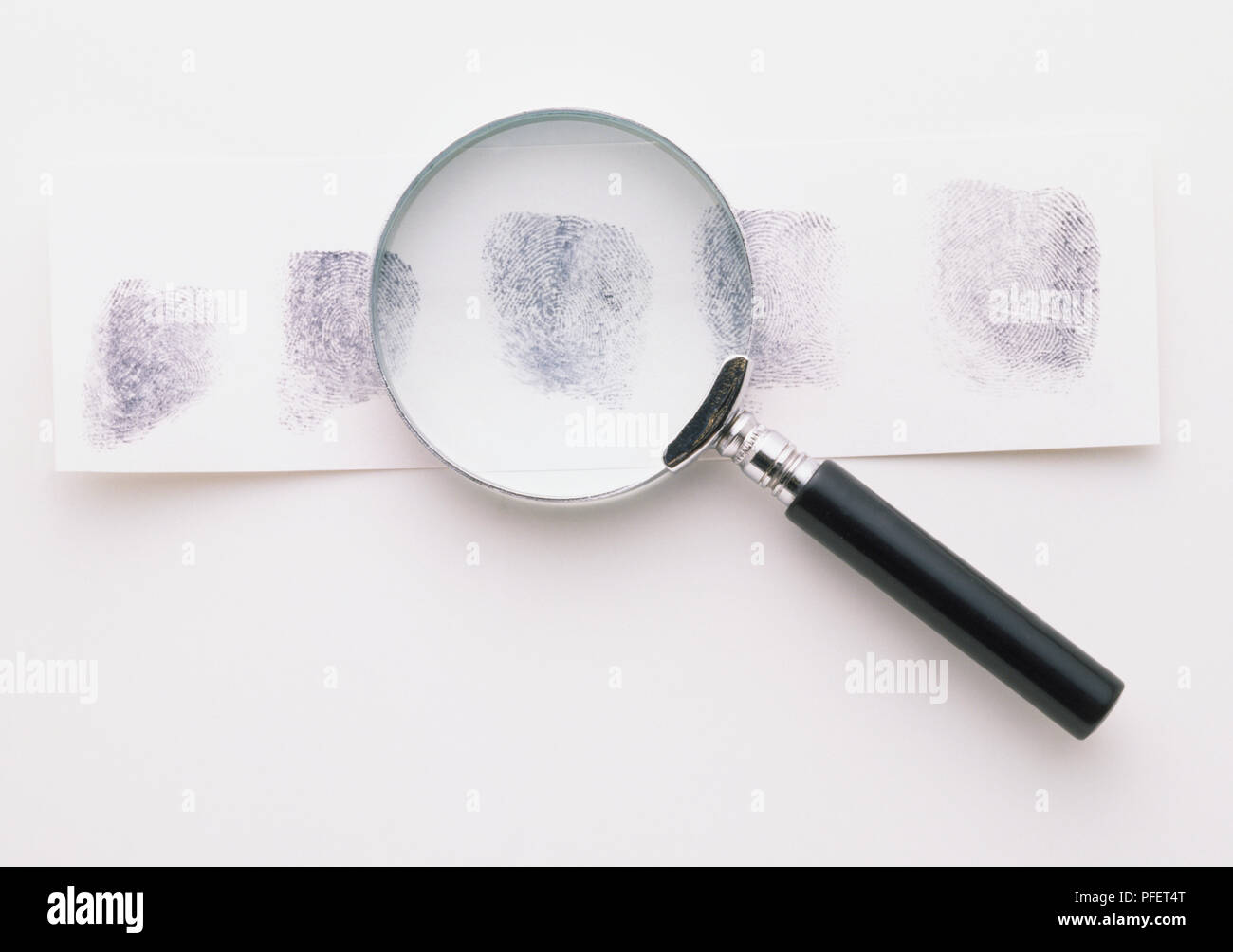 FINGERPRINTS AND A MAGNIFYING GLASS Stock Photo - Alamy