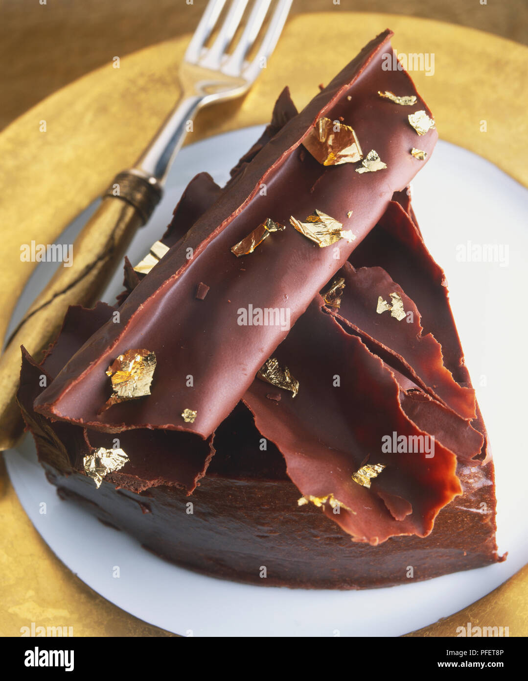 Slice of chocolate cake decorated with gold glitter Stock Photo - Alamy