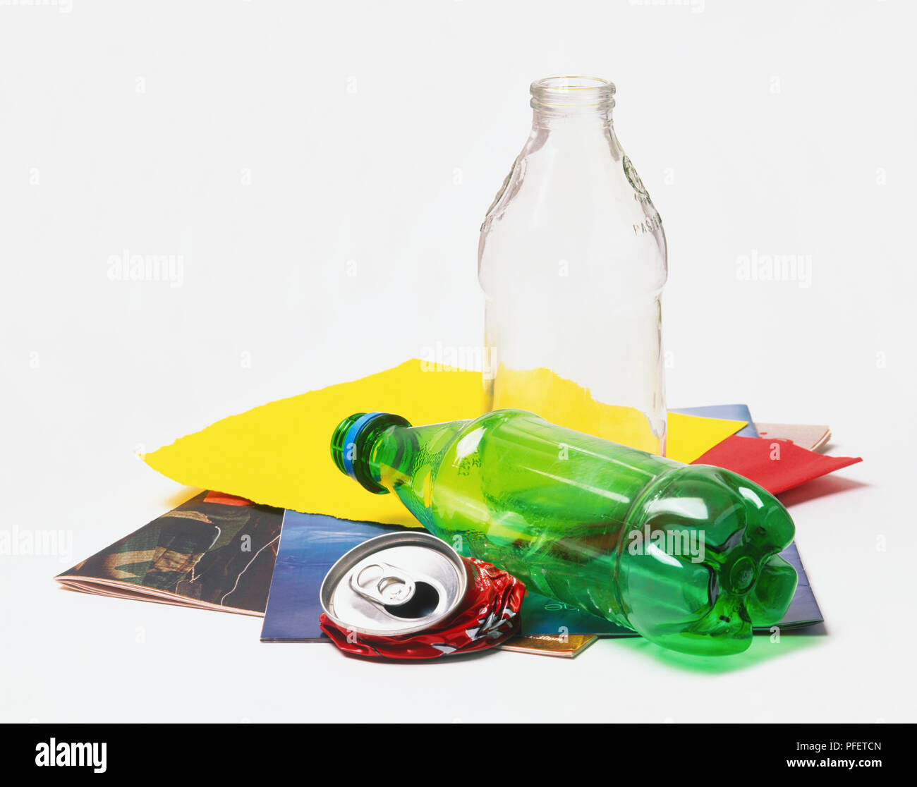 A glass bottle, a plastic bottle, a squashed can and some paper Stock ...