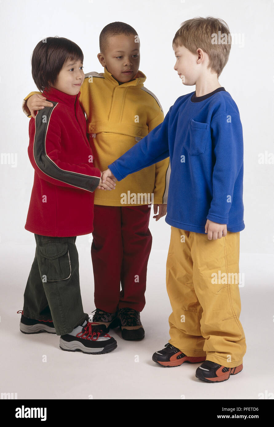 Three boys, two shaking hands Stock Photo - Alamy