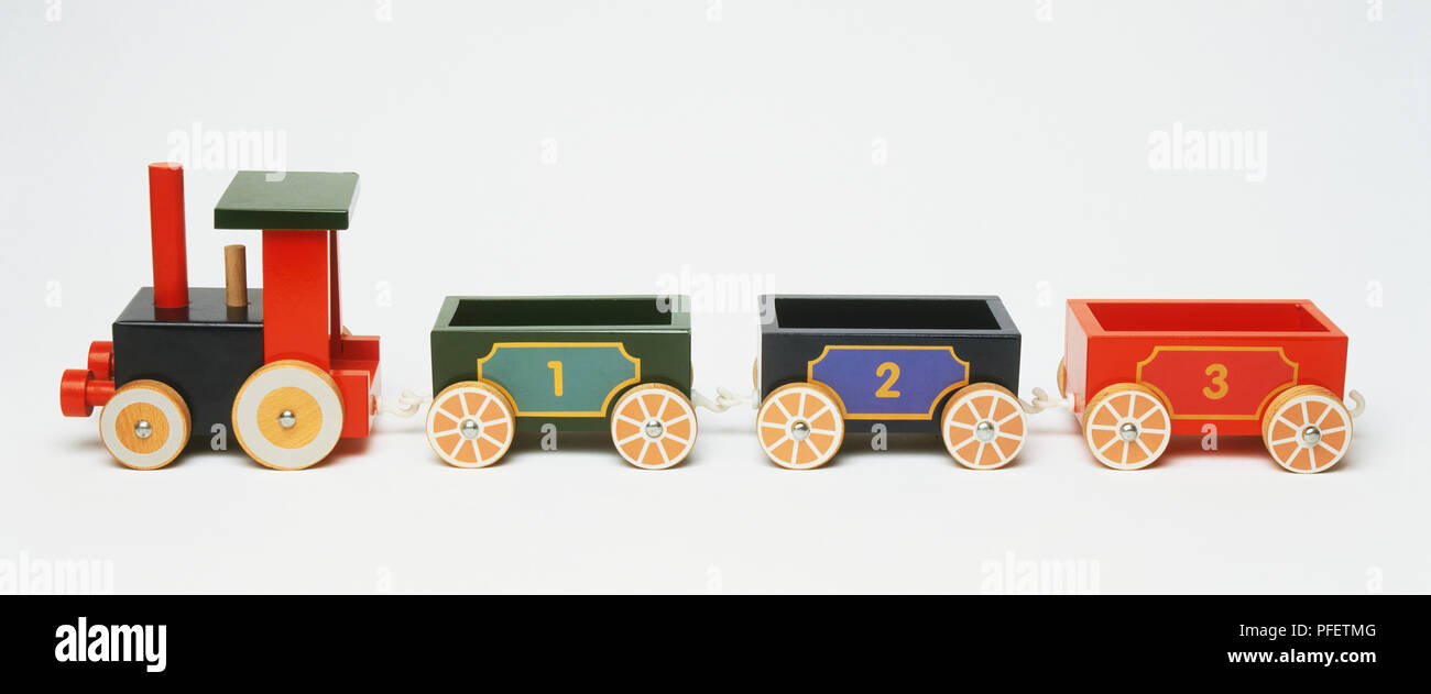 Toy locomotive pulling trailers, side view Stock Photo - Alamy