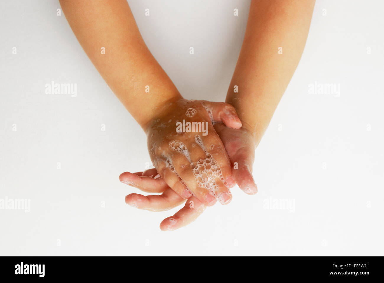 Boy washing hands with soap Stock Photo - Alamy