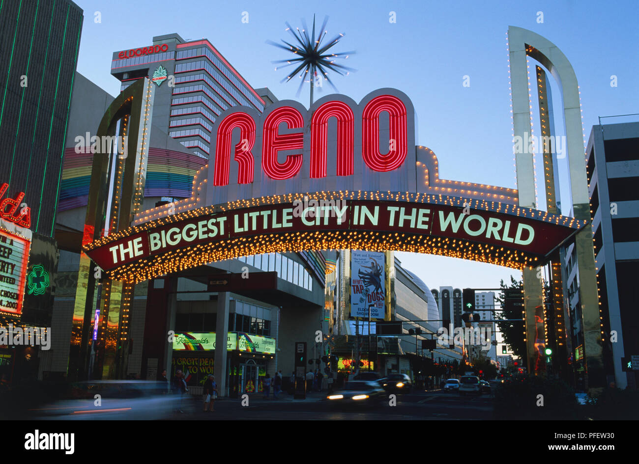 USA, Nevada, Downtown Reno, traffic passing below neon sign archway ...