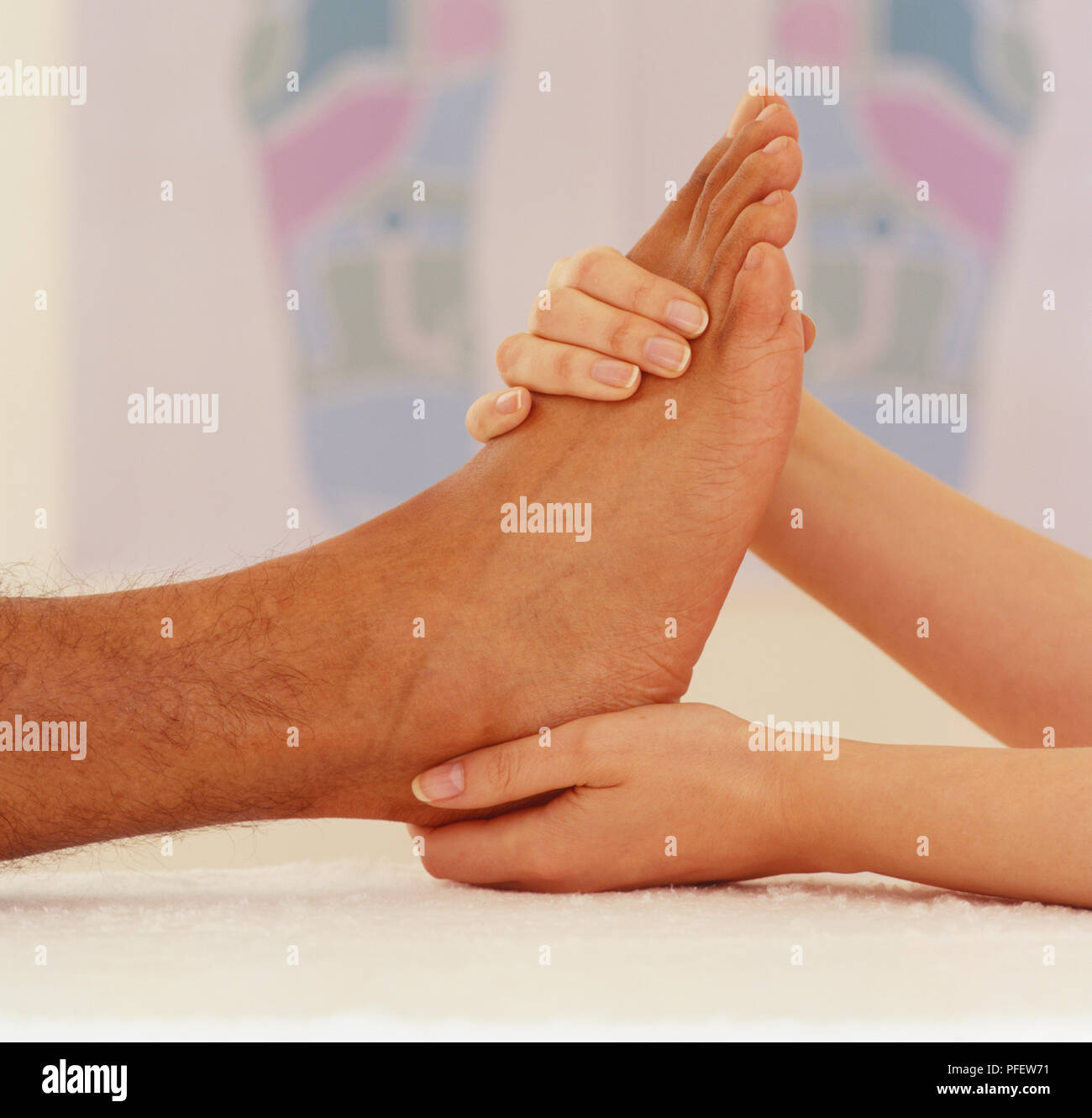 Rotating foot on point using hands grasping heel and toes Stock Photo ...