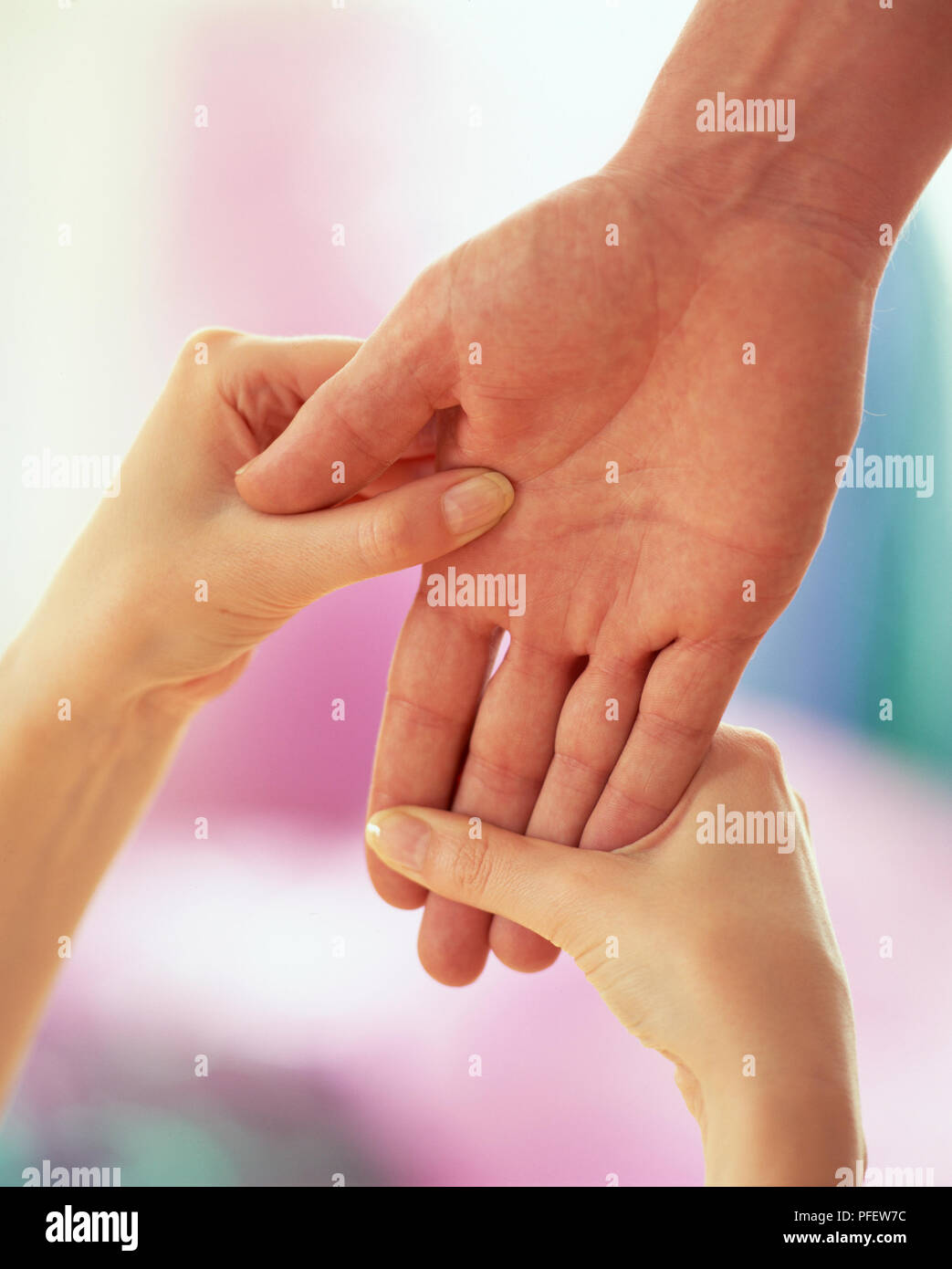 Holding hand with right working hand, using left thumb to apply thumb ...