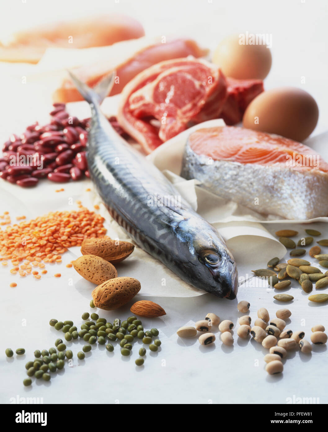 Meat, fish and pulses laid out on a table Stock Photo - Alamy