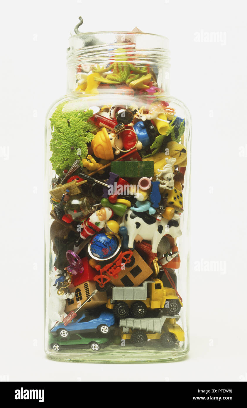 Glass jar full of toys, side view Stock Photo - Alamy
