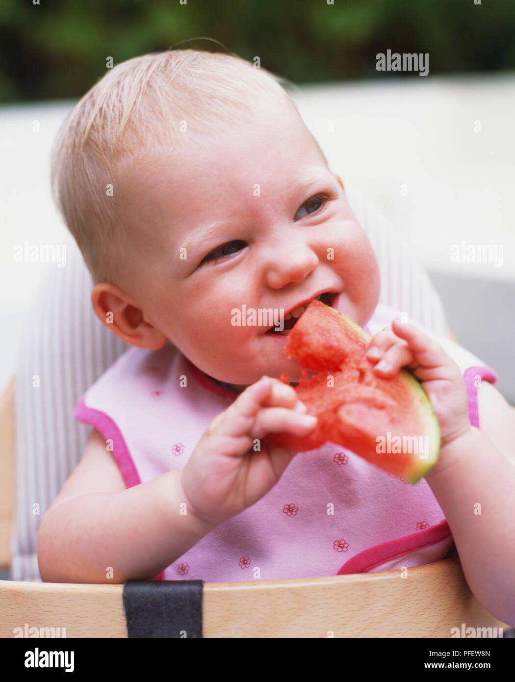 Baby eating a slice of watermelon Stock Photo - Alamy