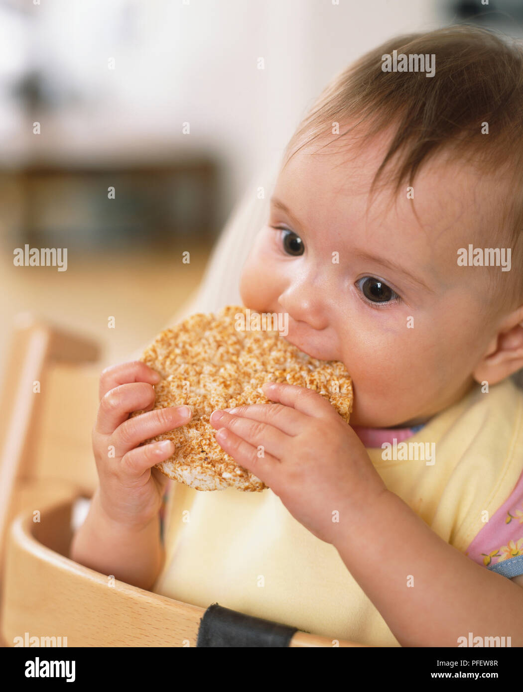 Baby eating a rice cake Stock Photo - Alamy