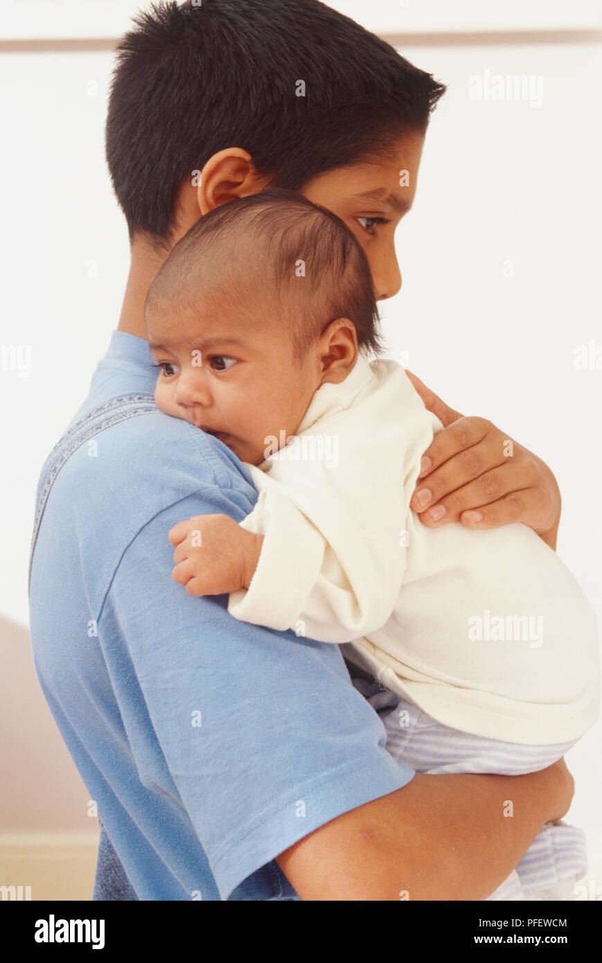 Teenage Guy Holding Baby