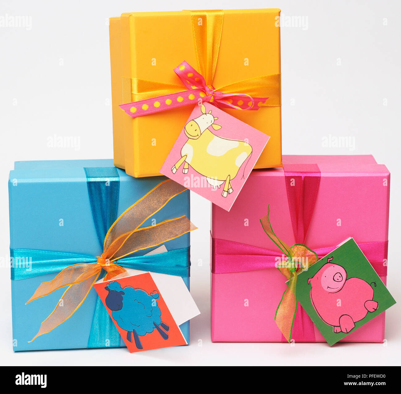 Three gift boxes with bows and animals tags, stacked on their sides in ...