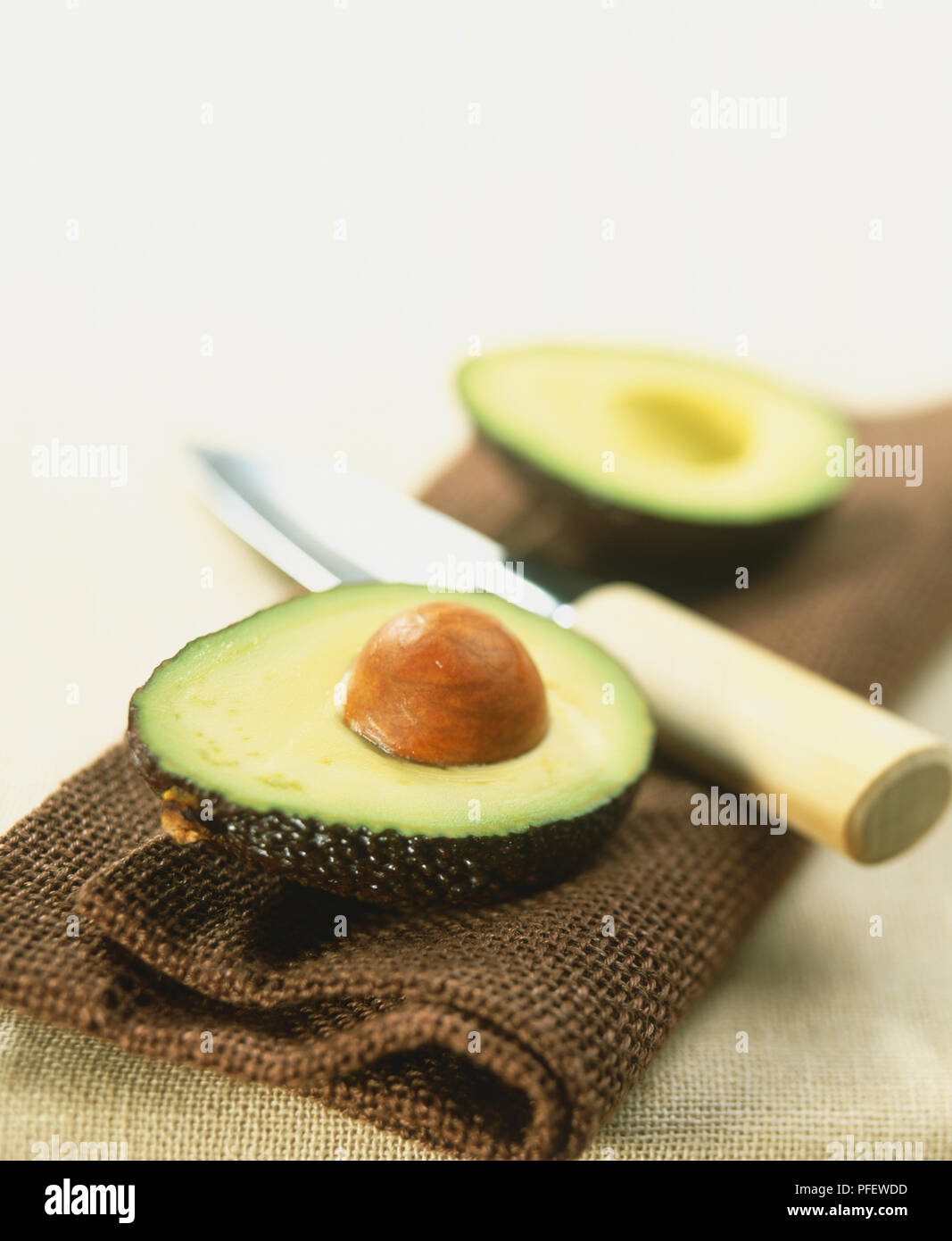 Avocado cut in half, showing stone Stock Photo - Alamy