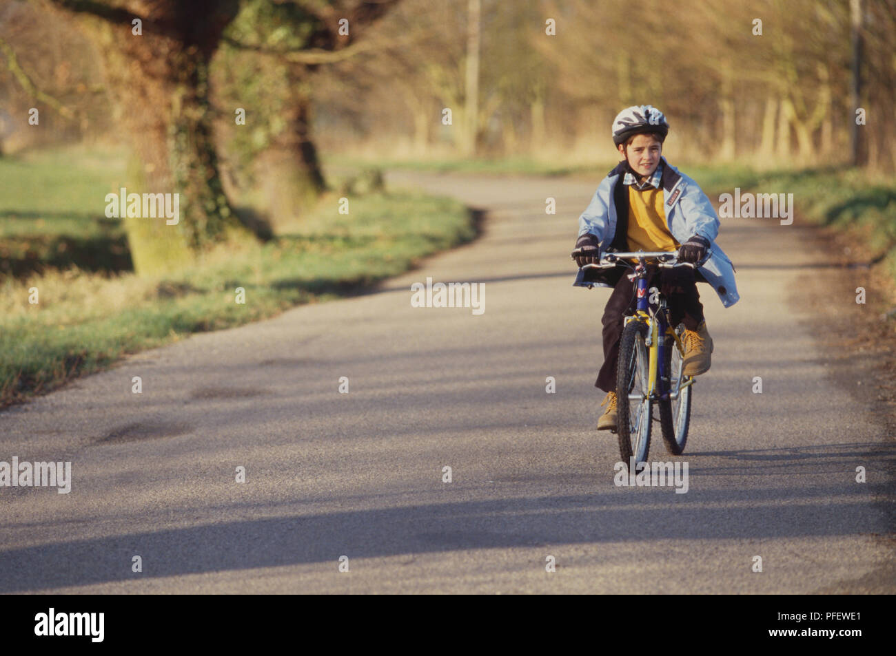 Boy riding a bike on the road Stock Photo - Alamy