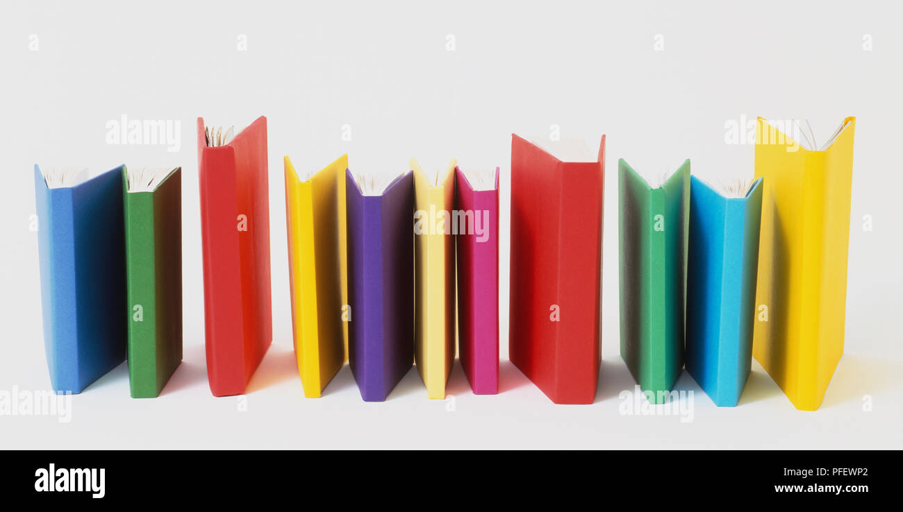 Row of books with colourful covers standing next to each other Stock ...