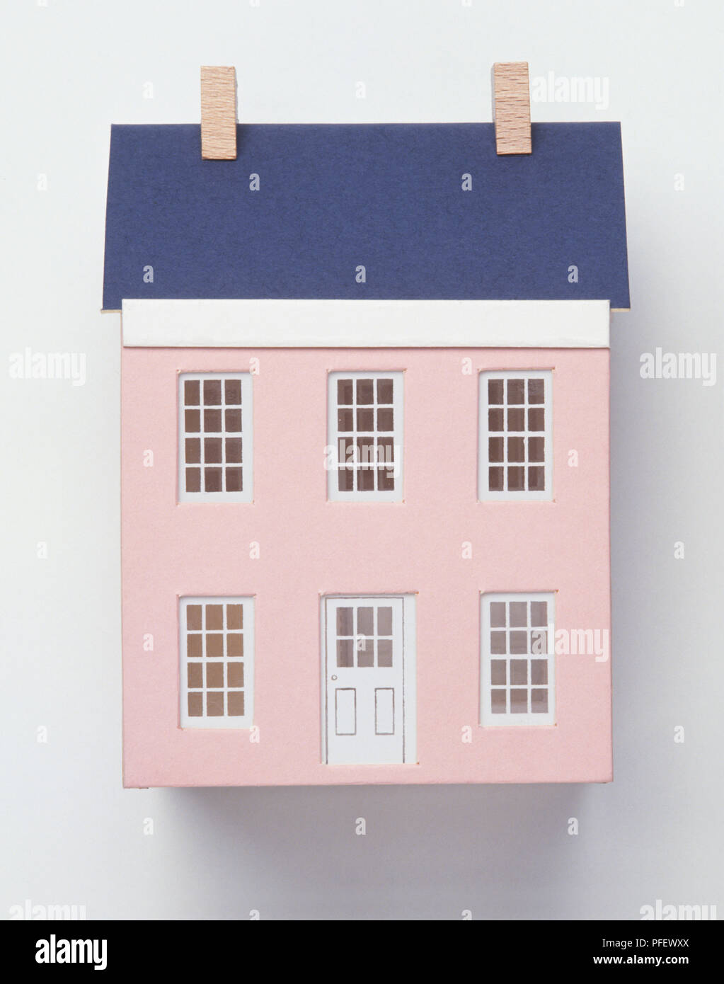 Pink house with blue roof, front view Stock Photo - Alamy
