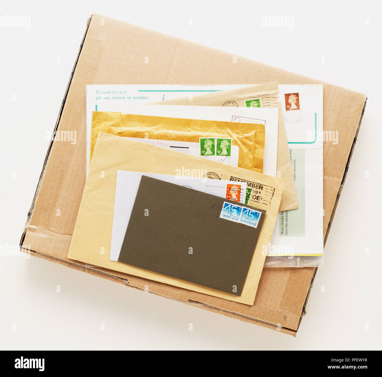 Pile of stamped letters on carton parcel, view from above Stock Photo ...