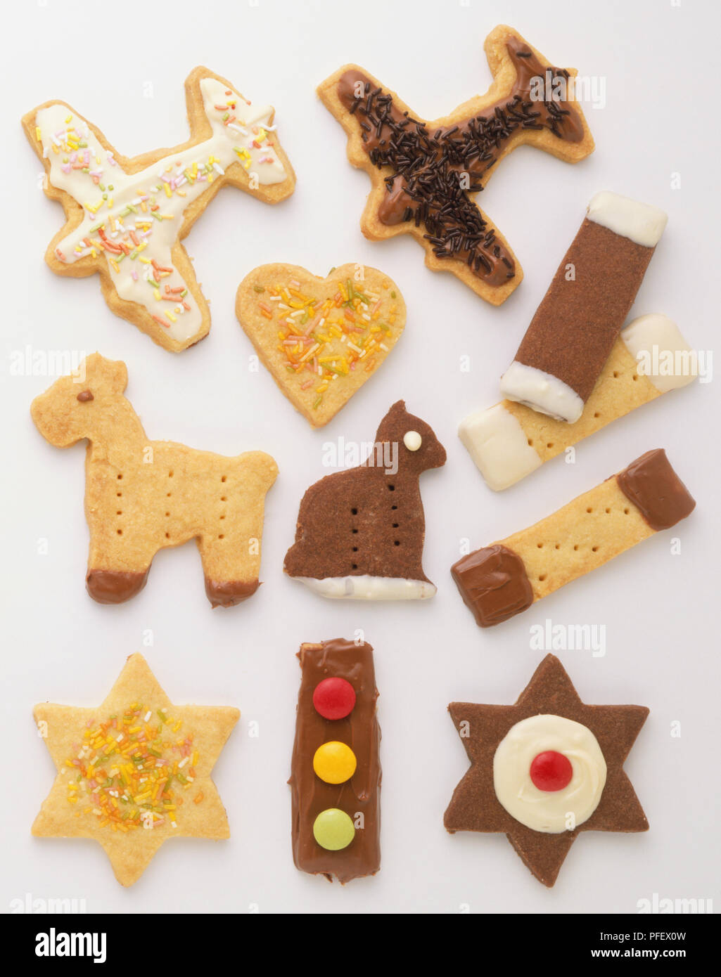 Selection of differently shaped biscuits with sweet toppings Stock ...
