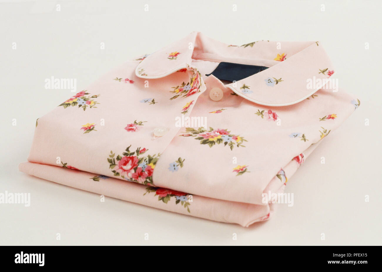 Folded pink pyjamas with floral pattern Stock Photo - Alamy