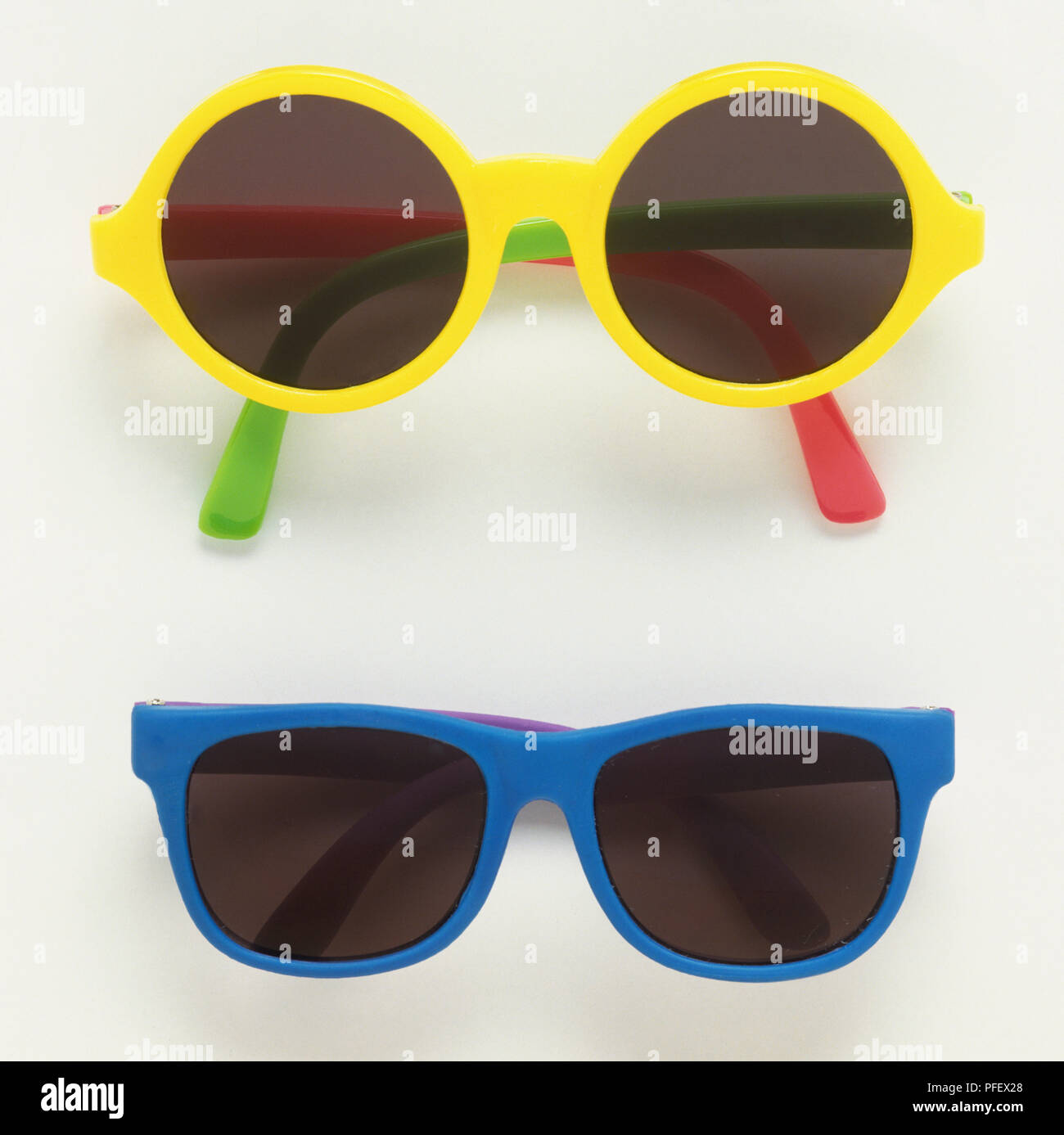 Two pairs of different coloured sunglasses with plastic frames Stock ...