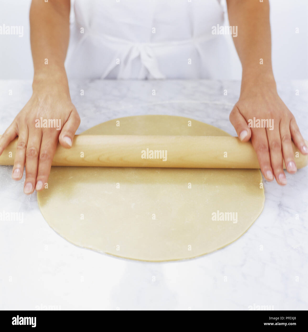 Pastry being rolled with rolling pin, high angle view Stock Photo - Alamy