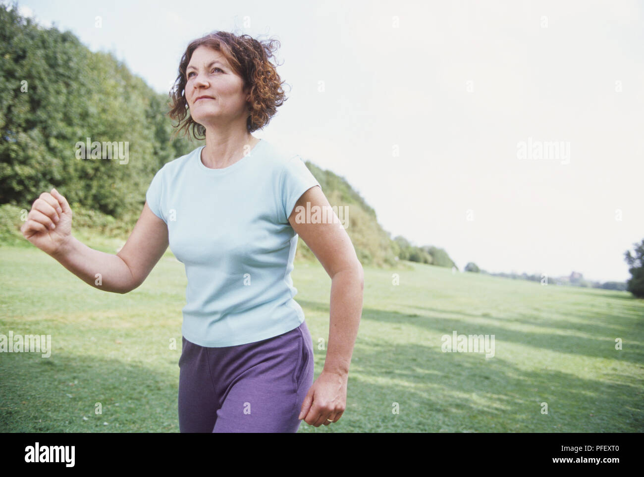 Woman power walking across hi-res stock photography and images - Alamy