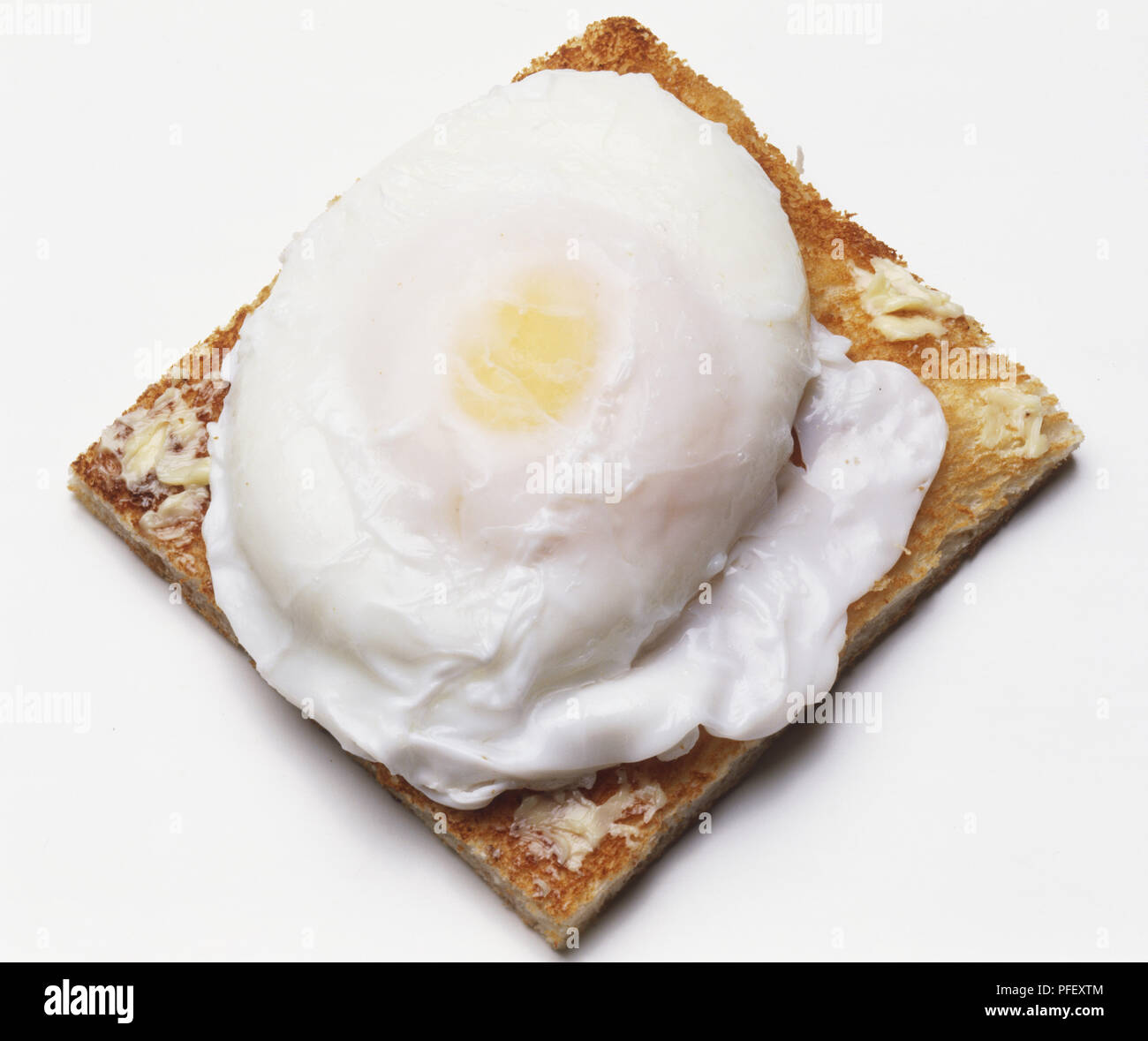 Poached egg on square slice of toast, view from above Stock Photo - Alamy