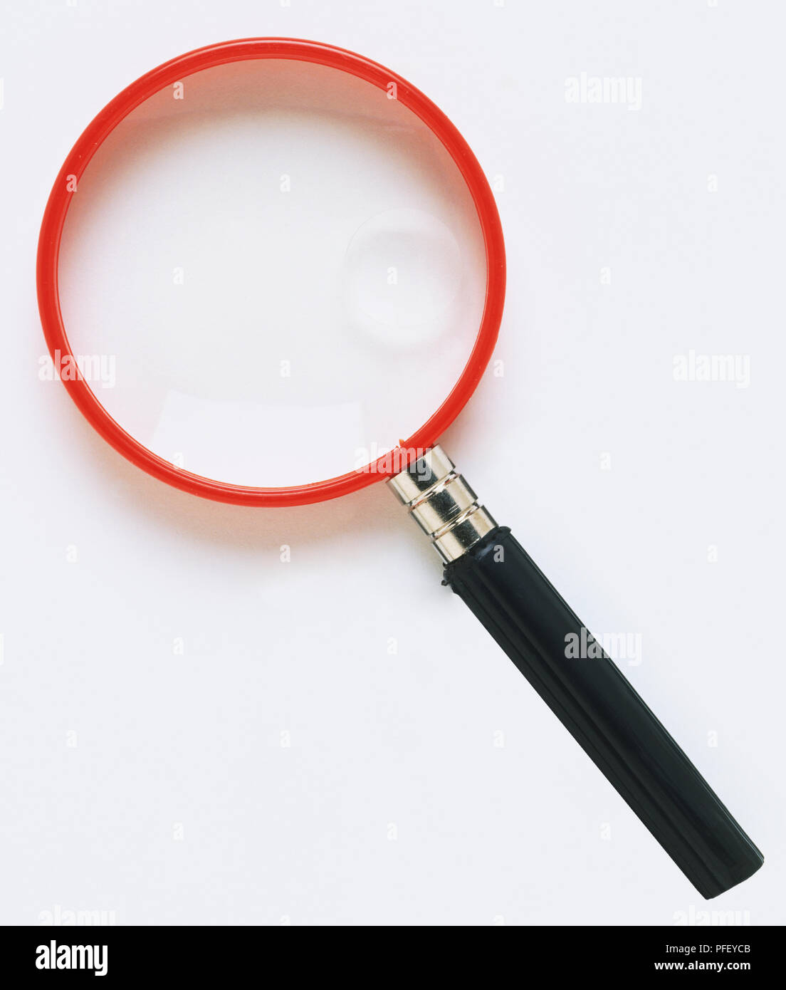 Loupe with red rim and black handle Stock Photo - Alamy