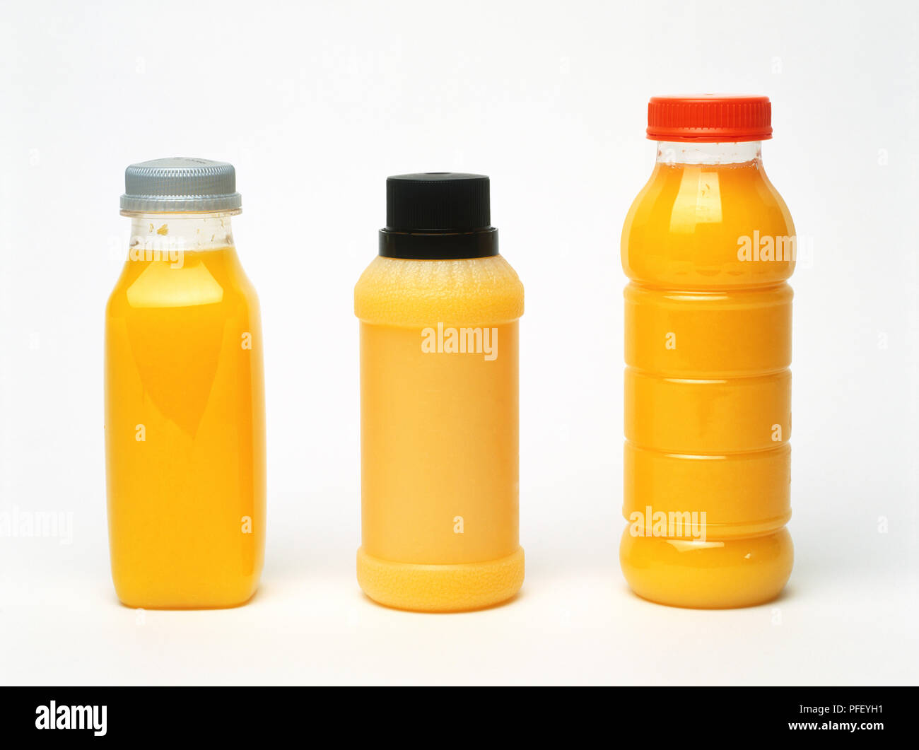 Three different plastic bottles of fruit juice Stock Photo - Alamy