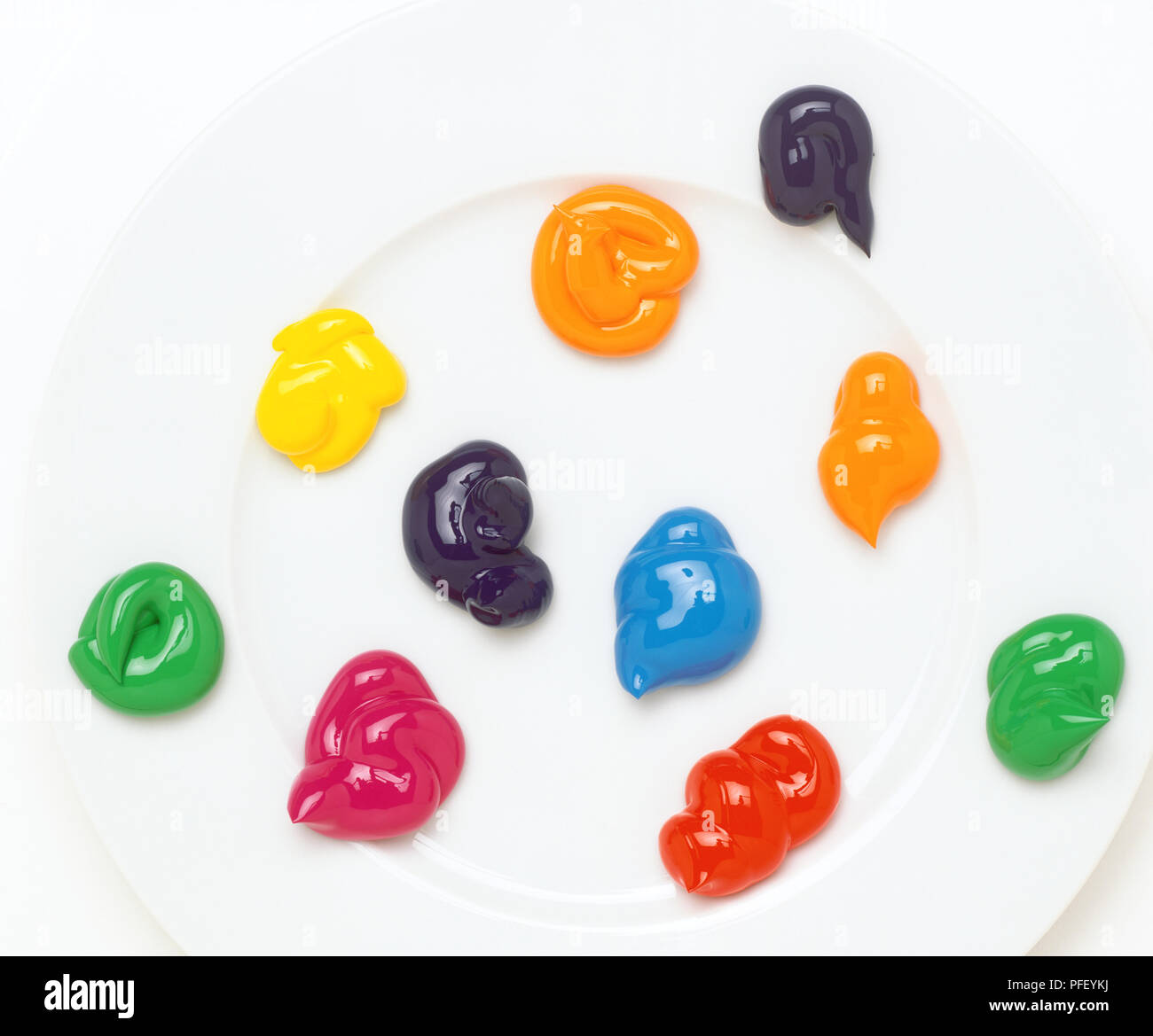 Blobs of different coloured paint on white plate, view from above Stock ...