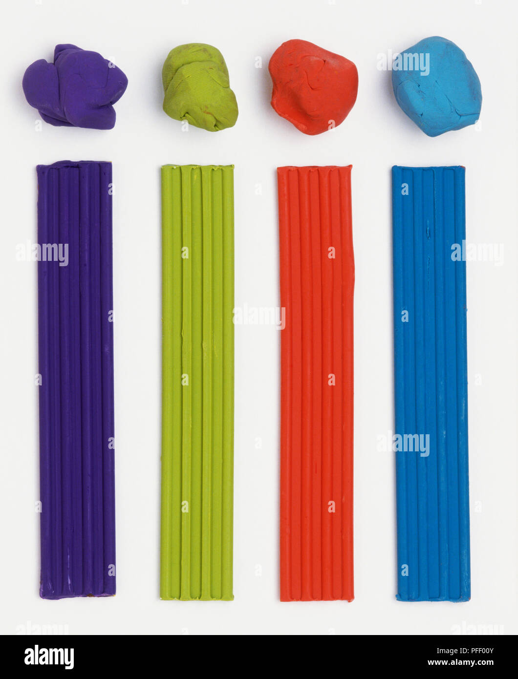 Strips and balls of modelling clay, dark blue, lime green, red and ...