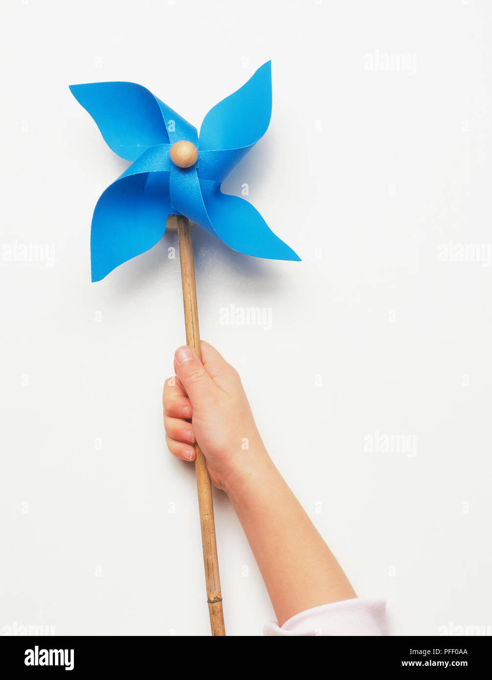 Hand holding blue paper windmill, front view Stock Photo - Alamy