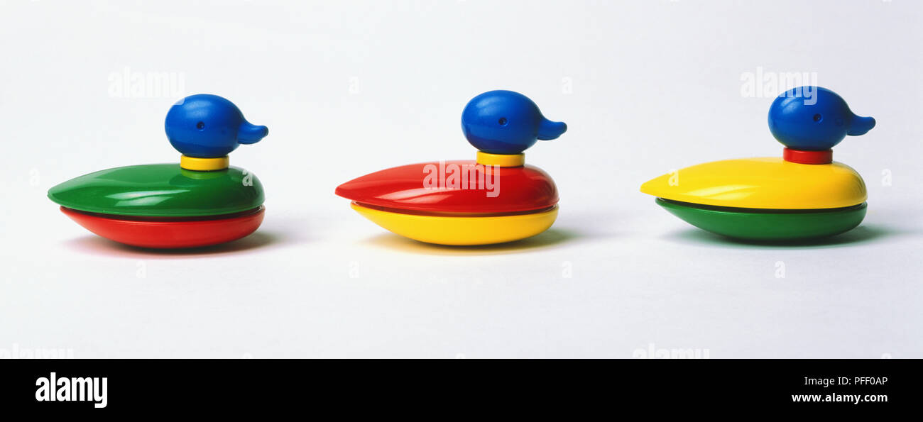 Line of three colourful toy ducks, side view Stock Photo - Alamy