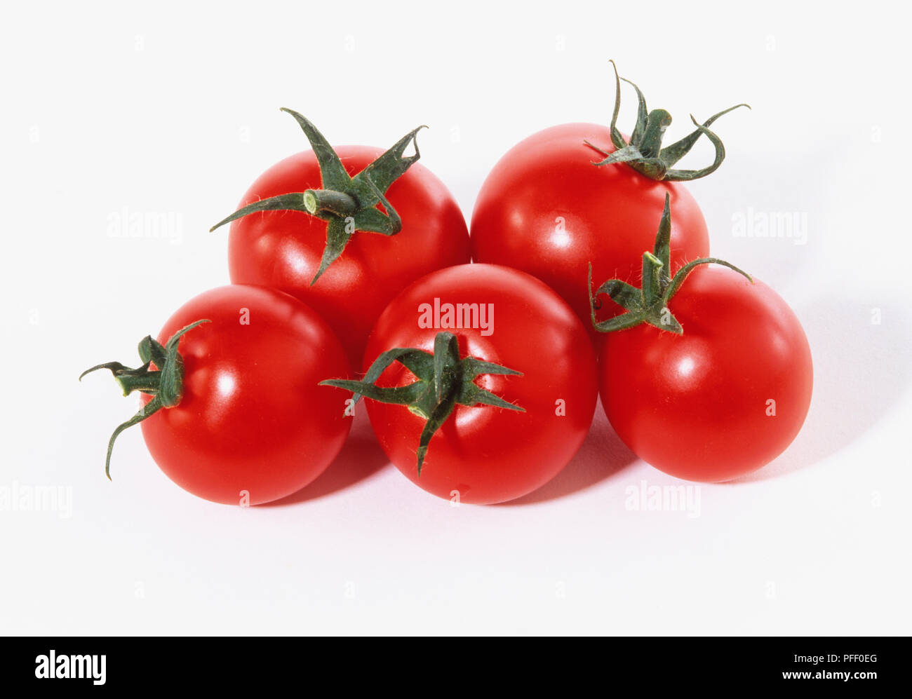 Five cherry tomatoes with stems, side view Stock Photo - Alamy