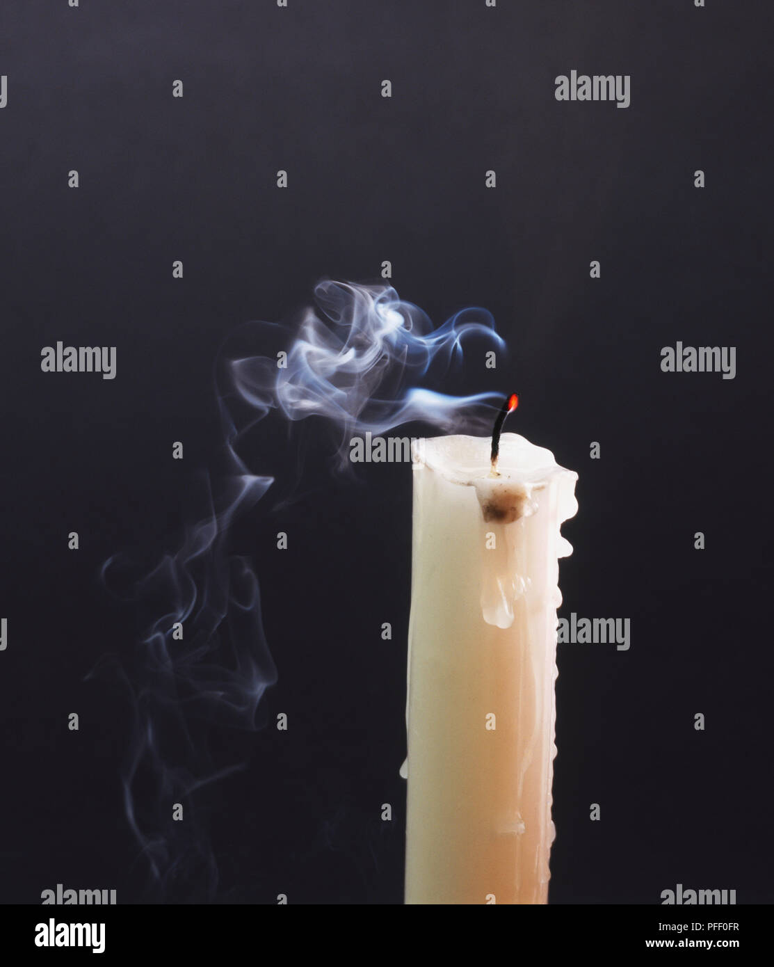 Smoke trailing from extinguished white candle, wick still glowing Stock ...