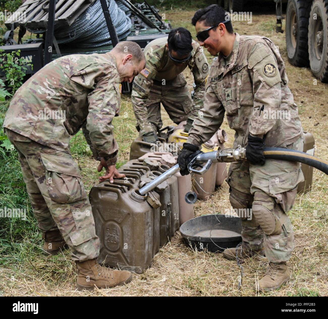 U.S. Army soldiers bring empty fuel cans to a refueling station ...