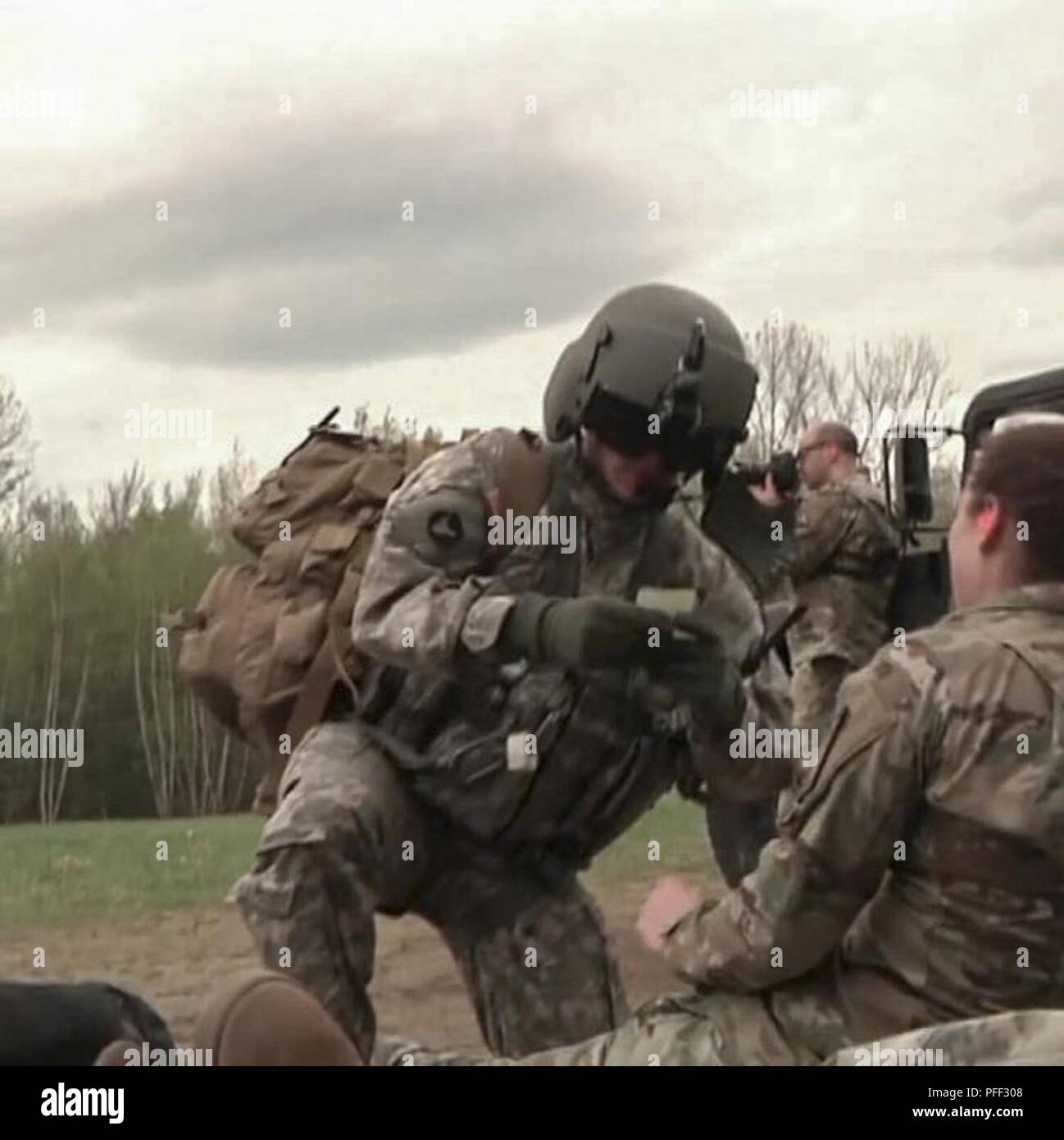 U.S. Army Staff Sgt. Tim Farrow, a flight paramedic, takes care of a ...