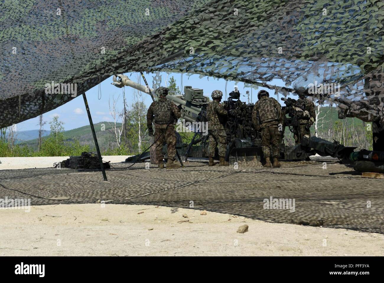 U.S. Soldiers assigned to Fort Wainwright, Alaska await orders to fire ...