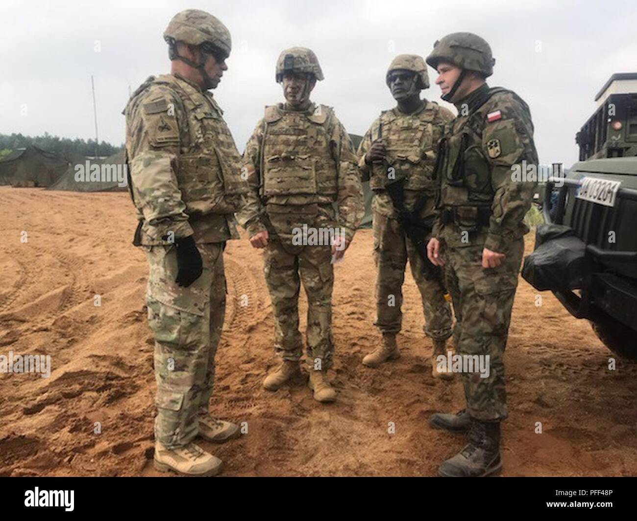 Chief Warrant Officer 3 Charles Garner (second from left) and Col ...
