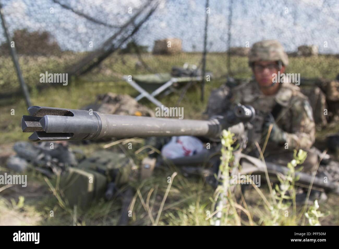 A Soldier conducts perimeter security with a M240 Machine Gun during ...
