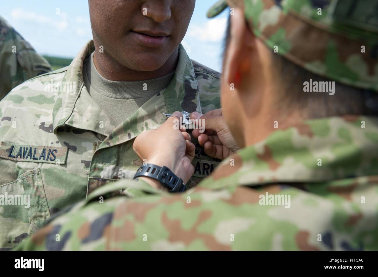 A Japan Ground Self-Defense Force soldier pins his jump wings on a ...