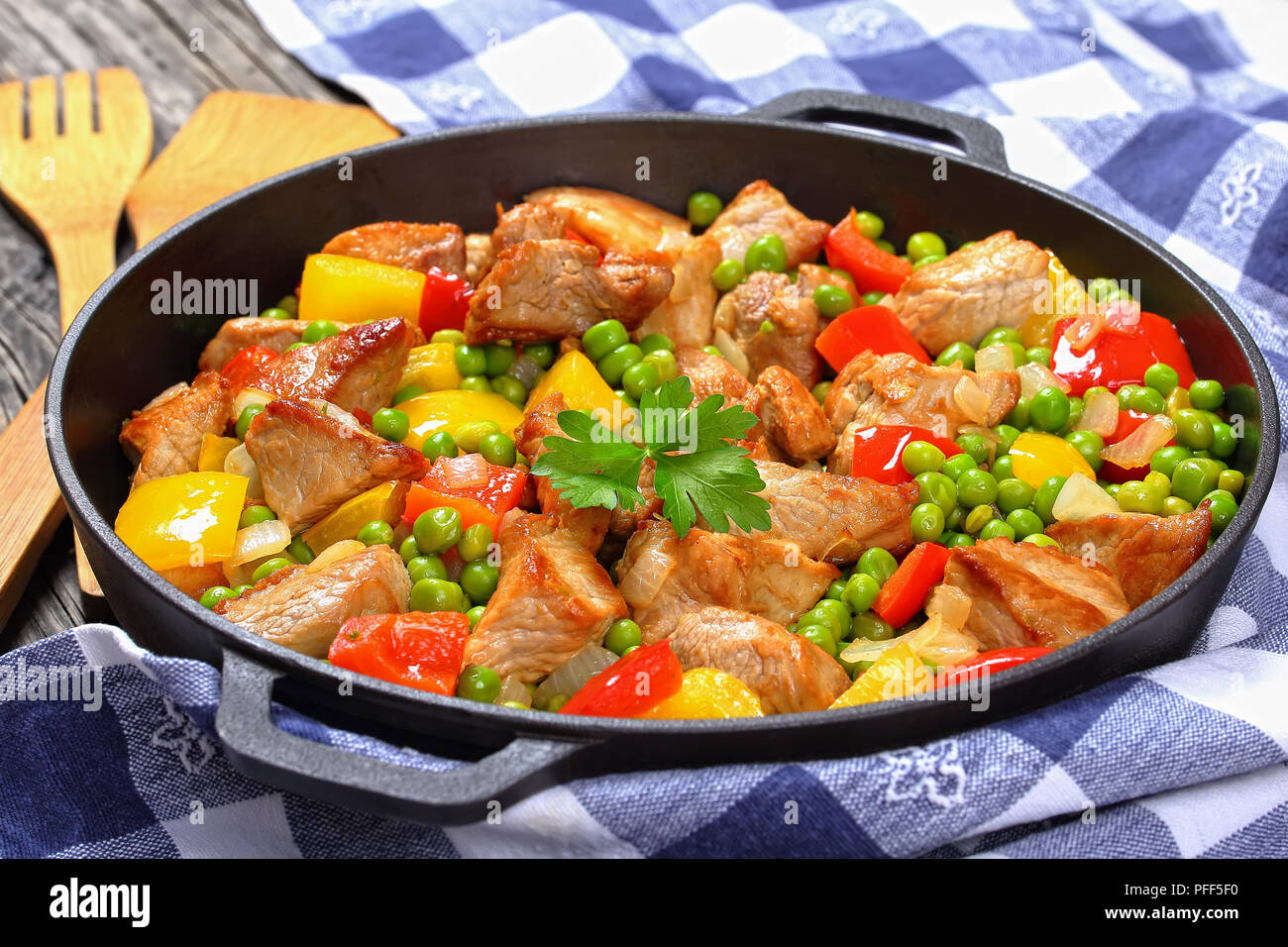 delicious stir fried meat chunks with green peas, onion, red and yellow ...