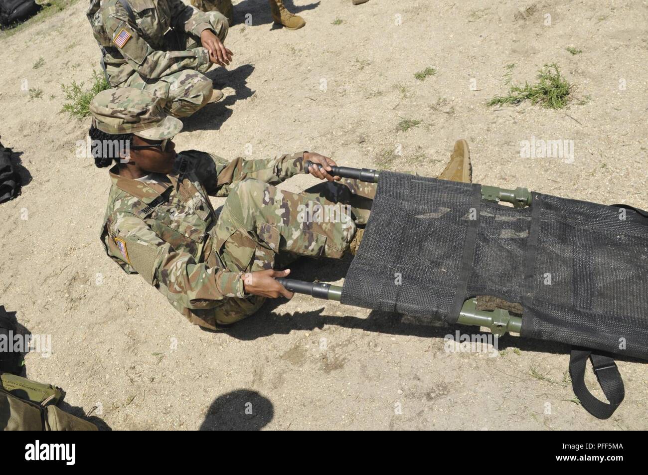 Spc. Shartrice Parker kicks open a folding rigid pole decontaminable ...