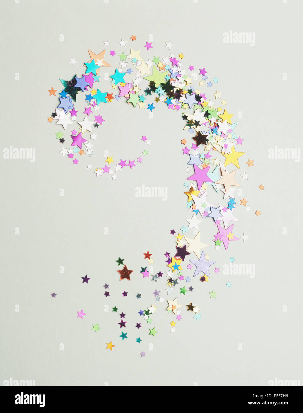 Shiny star shaped confetti arranged in a swirl Stock Photo - Alamy