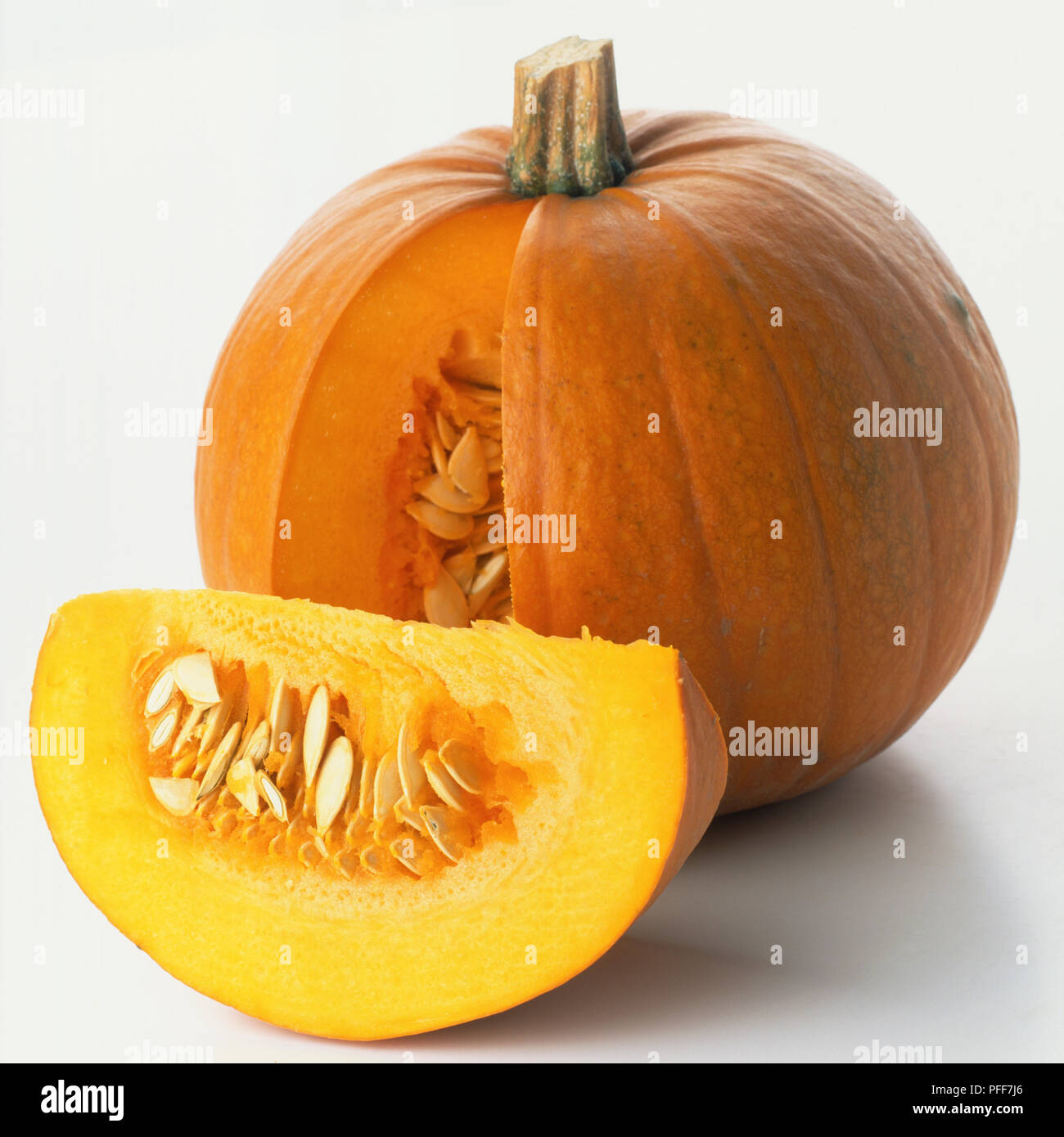 Pumpkin with slice removed, showing fleshy pulp, seeds, and orange rind ...