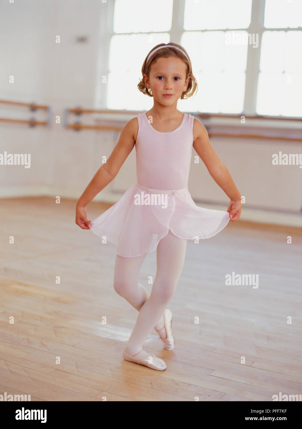 Young ballerina curtseying in middle of classroom Stock Photo - Alamy