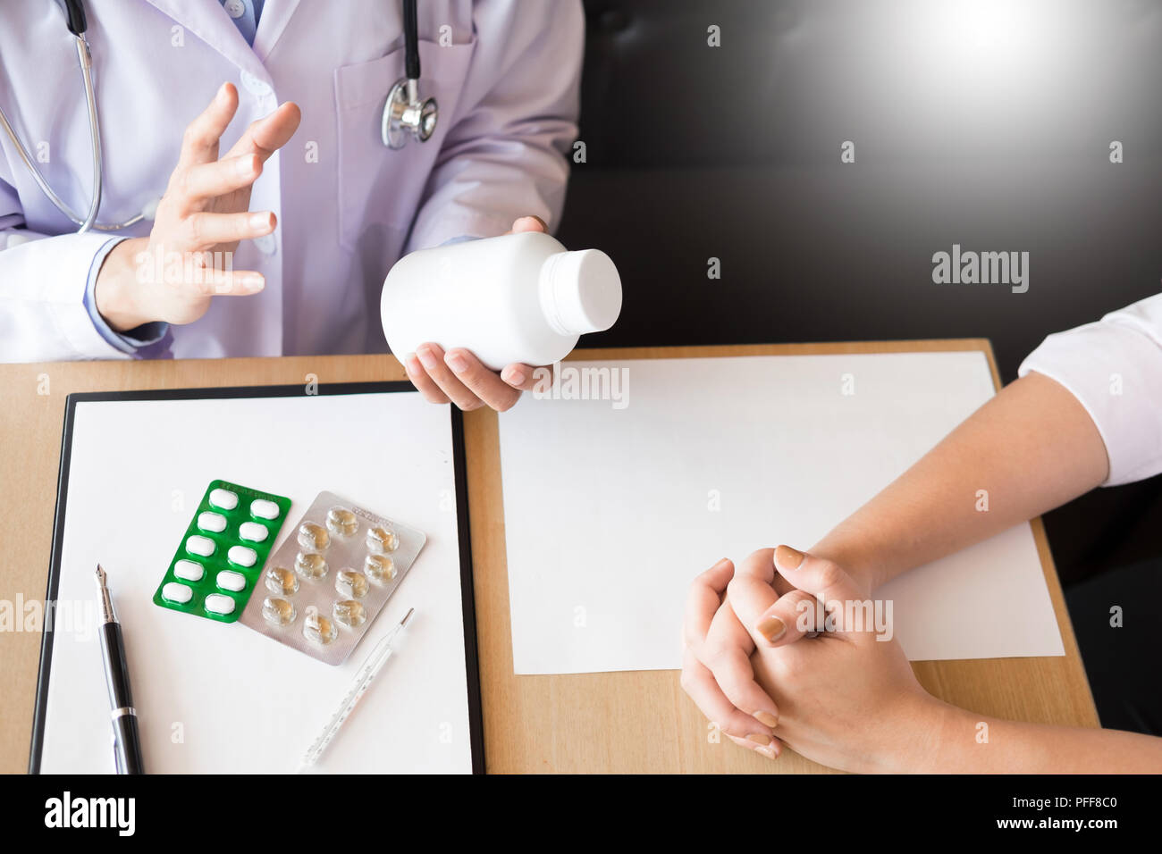 doctor hand holding tablet of drug and explain to patient in hospital ...