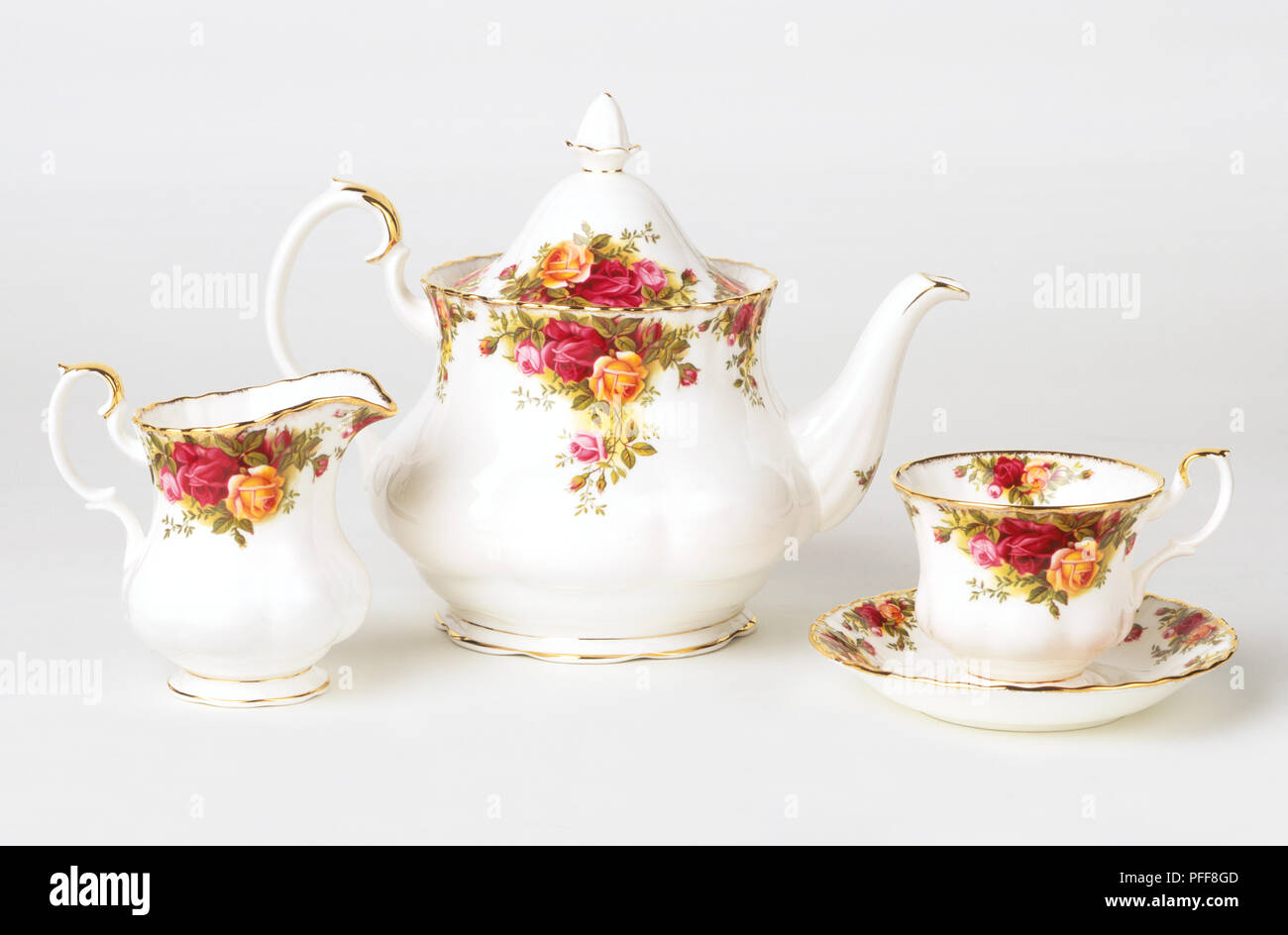 Three-piece china tea service decorated with a rose pattern Stock Photo ...