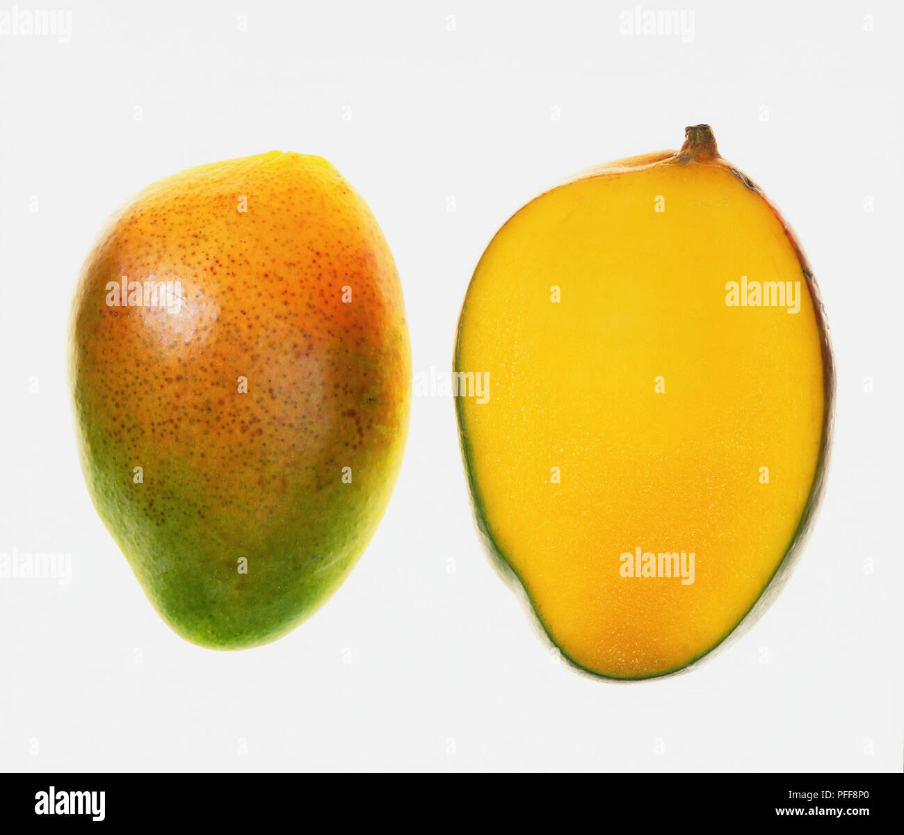Mango, whole and half Stock Photo - Alamy